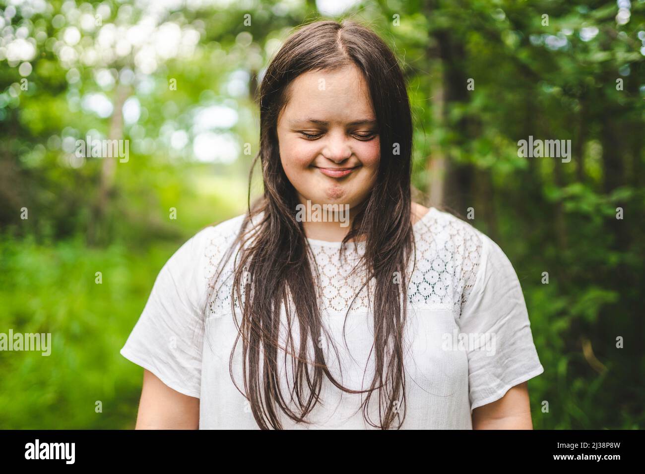 Portrait of trisomy adult outside having fun Stock Photo - Alamy