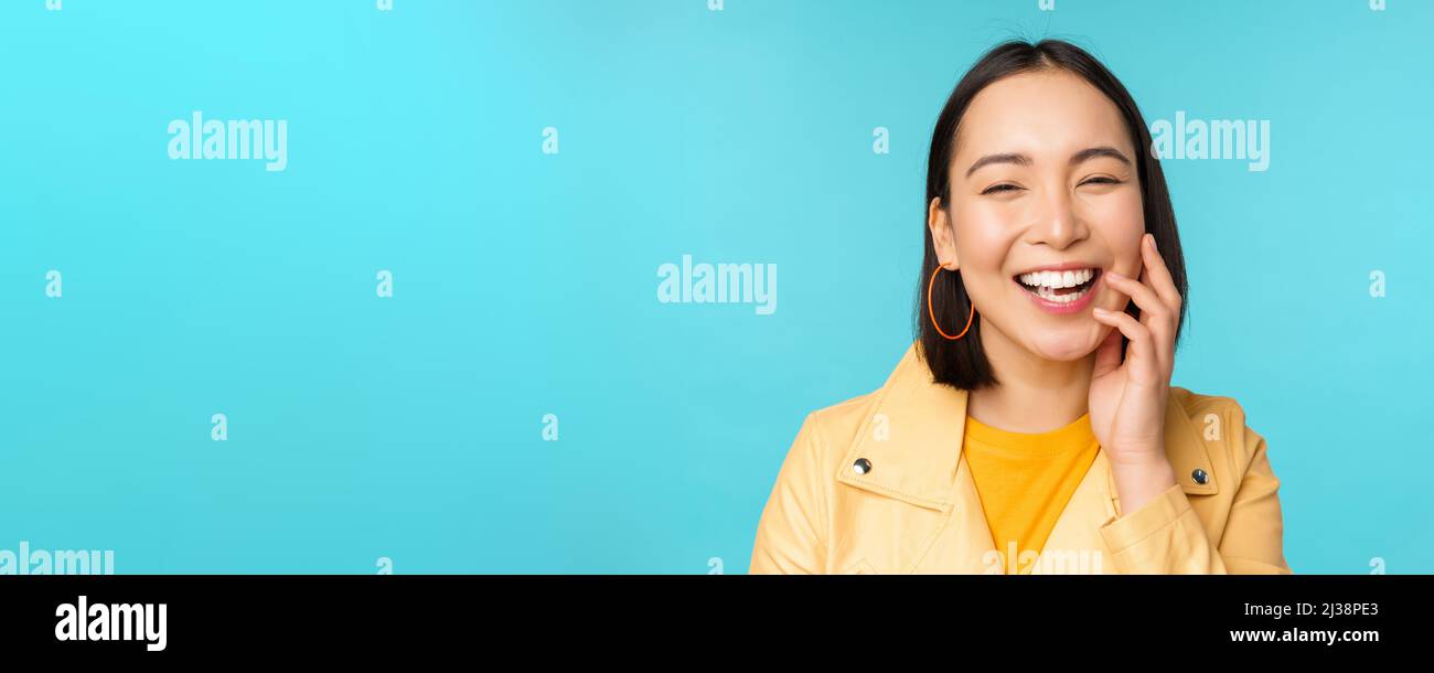 Close up portrait of natural asian girl laughing, smiling and looking ...