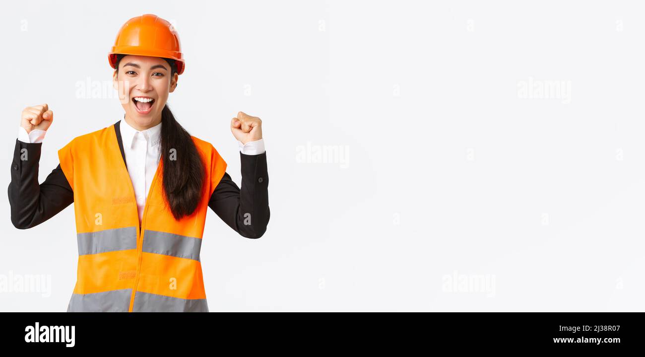 Successful winning female asian engineer fist pump and shout yes ...