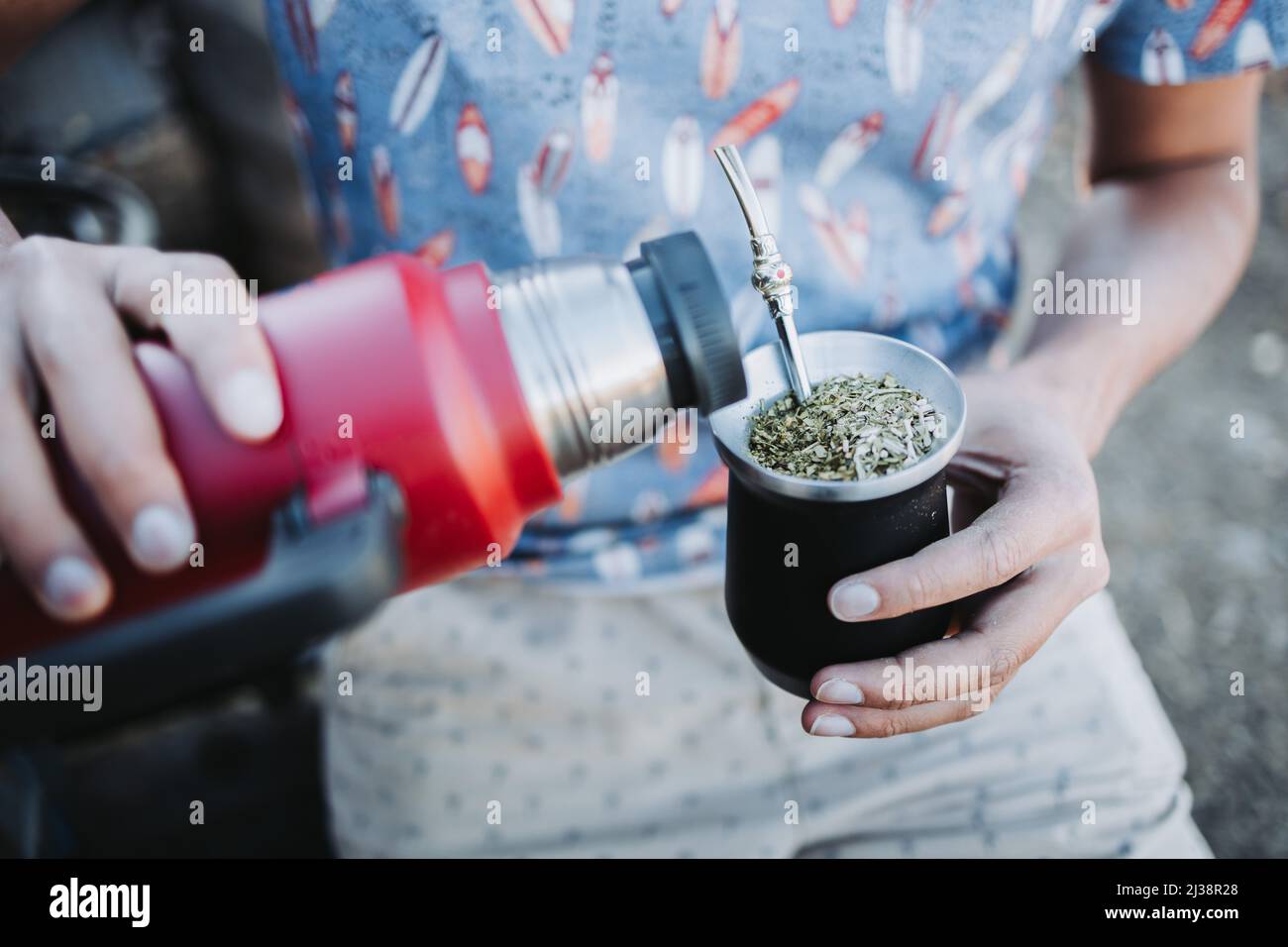 close up of a young latin man drinking mate in a natural space, at ...