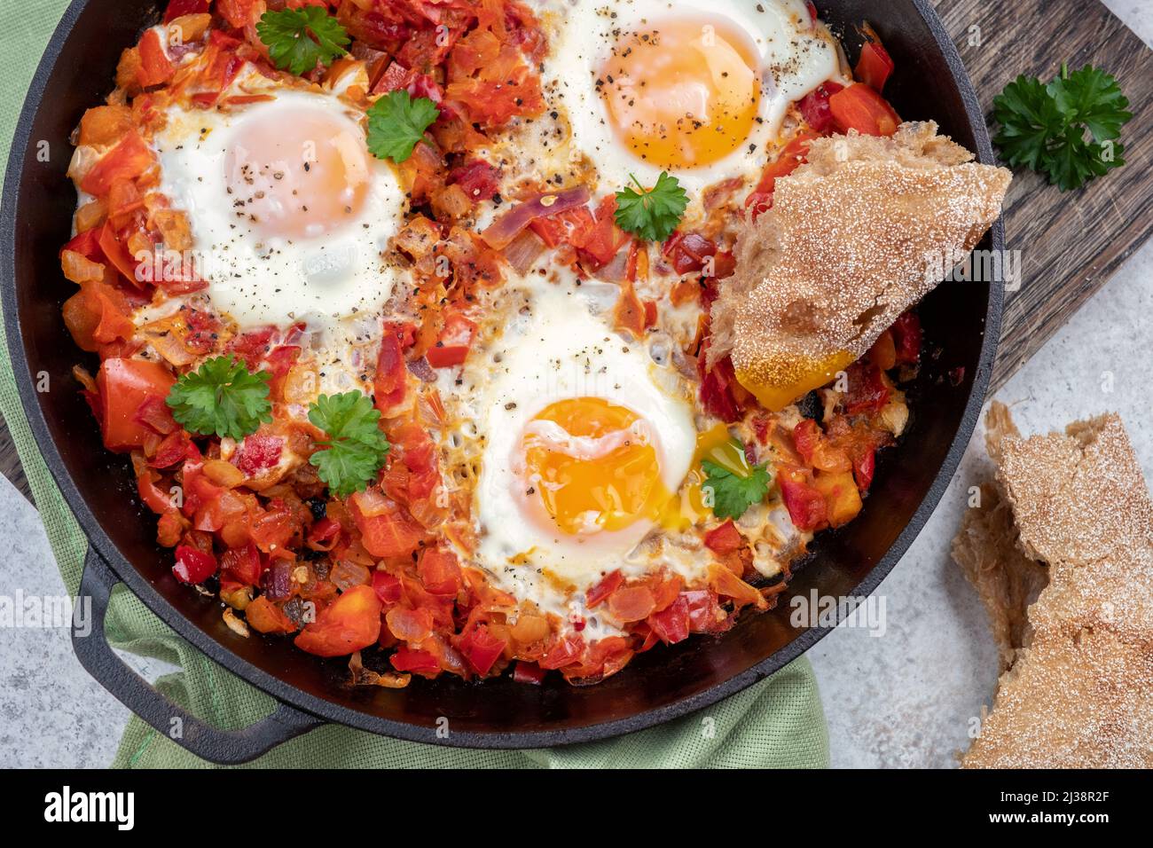 Shakshouka, eggs poached in sauce of tomatoes Stock Photo - Alamy