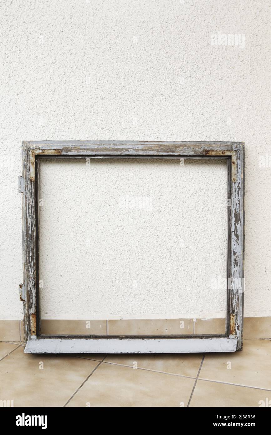 Old wooden window frame taken out of the building for renovation. Retro ...