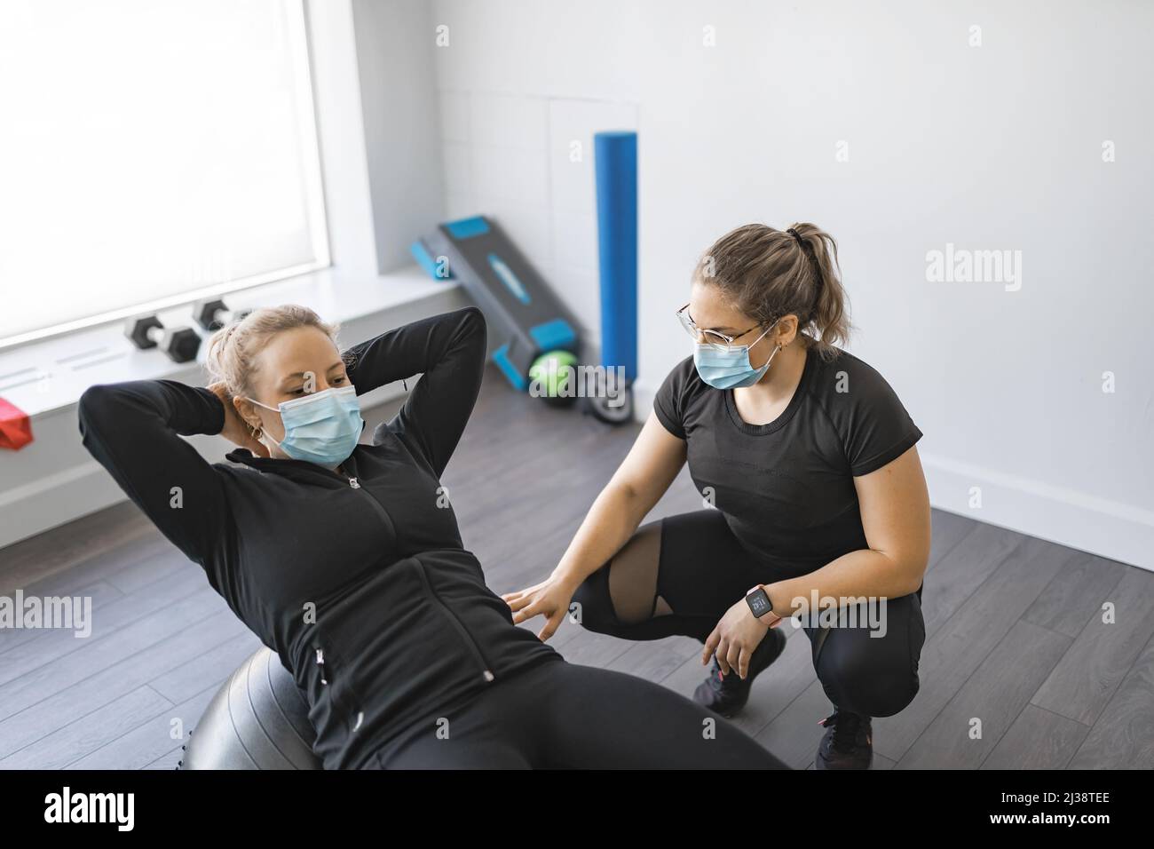 Trainer and client training at the gym Stock Photo - Alamy