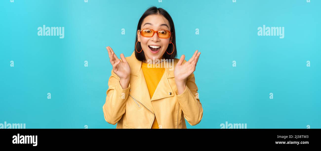 Image of enthusiastic young asian woman celebrating, triumphing ...