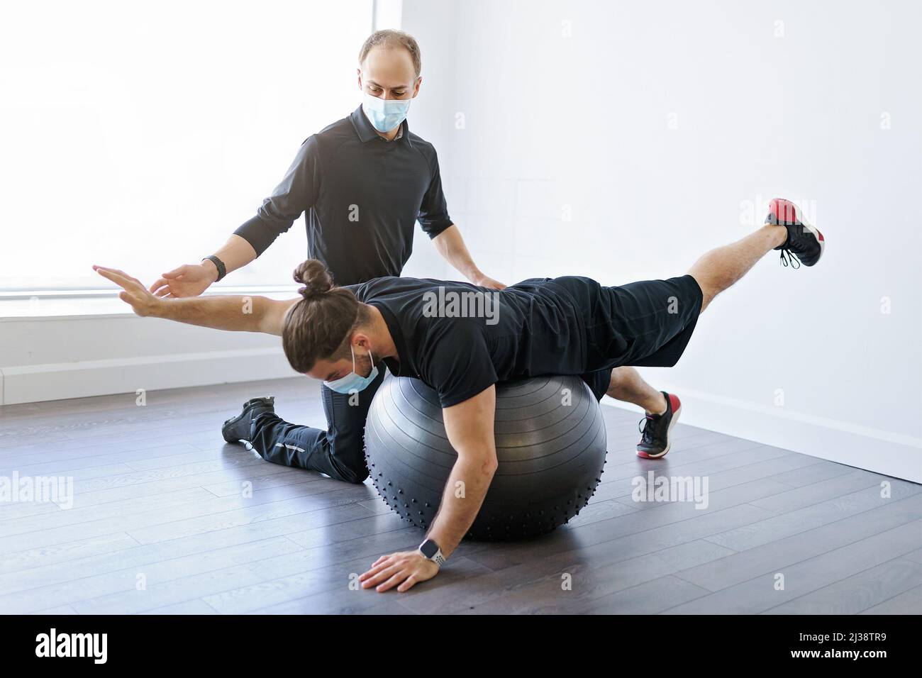 physiotherapist doing therapeutic exercises for patient at the clinic ...