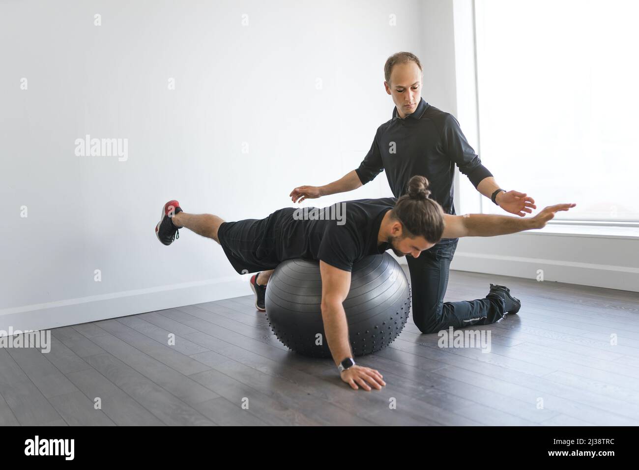 physiotherapist doing therapeutic exercises for patient at the clinic ...