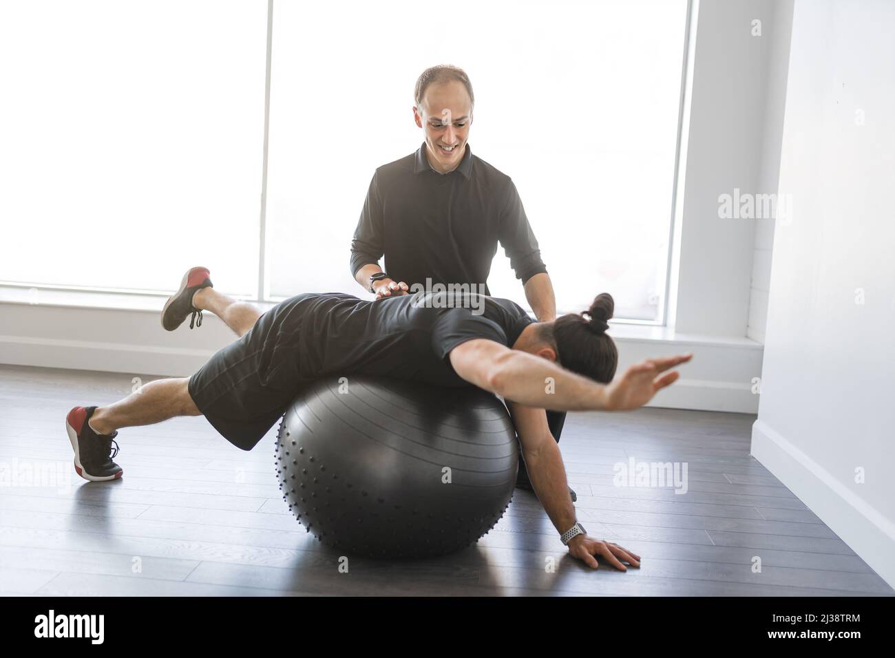 physiotherapist doing therapeutic exercises for patient at the clinic ...