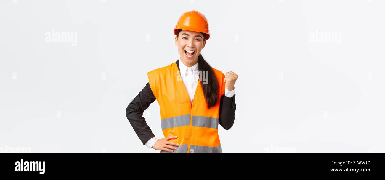 Successful businesswoman, construction manager in safety helmet, fist ...