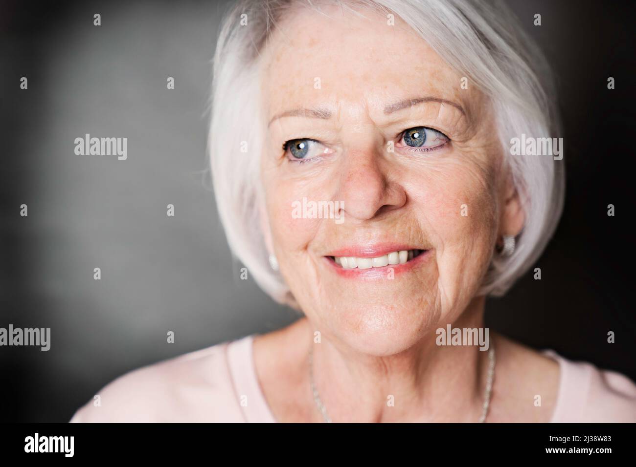 nice portrait of a retired senior woman on studio background Stock ...