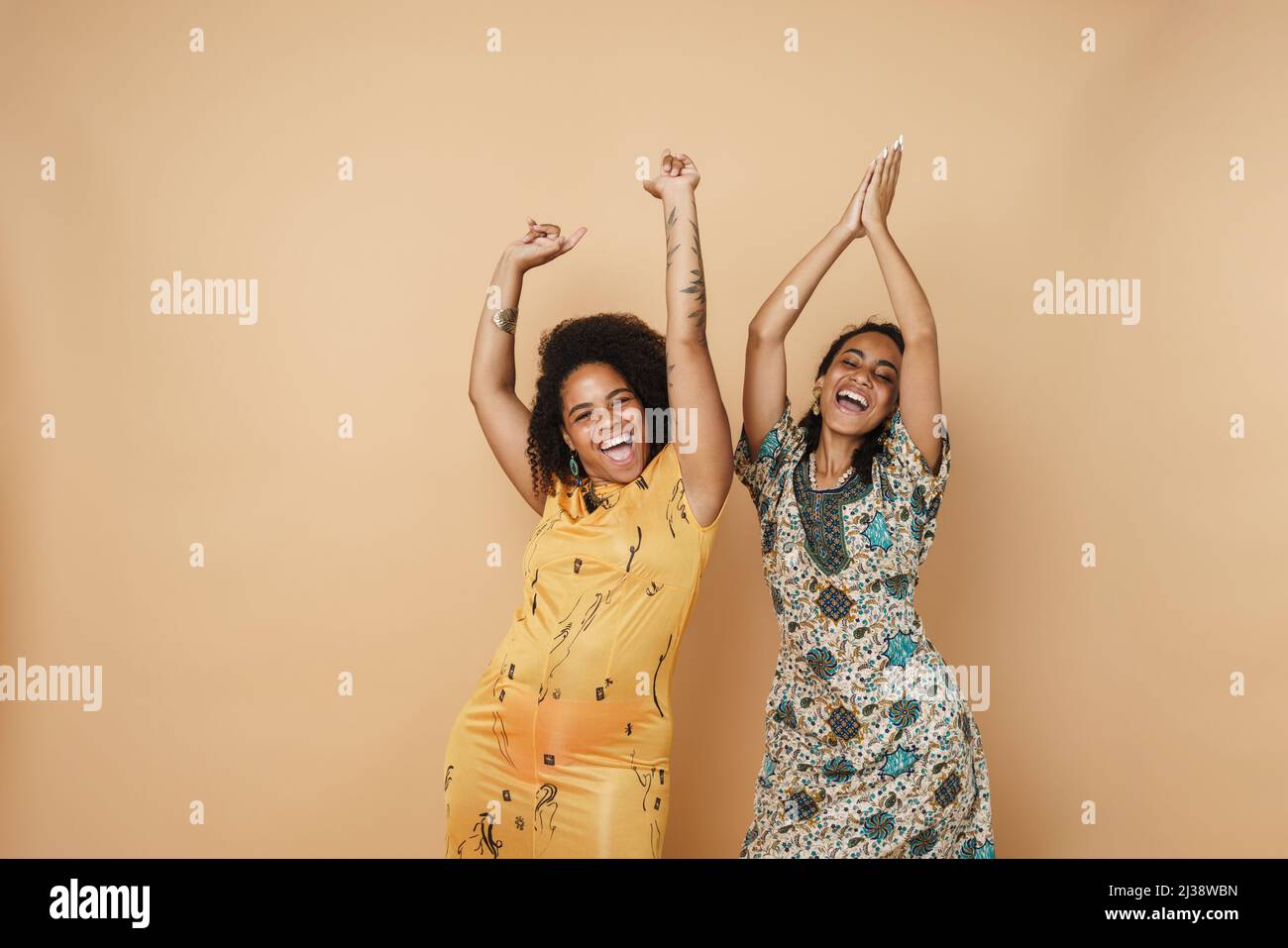 Young black two women dancing and laughing at camera isolated over ...
