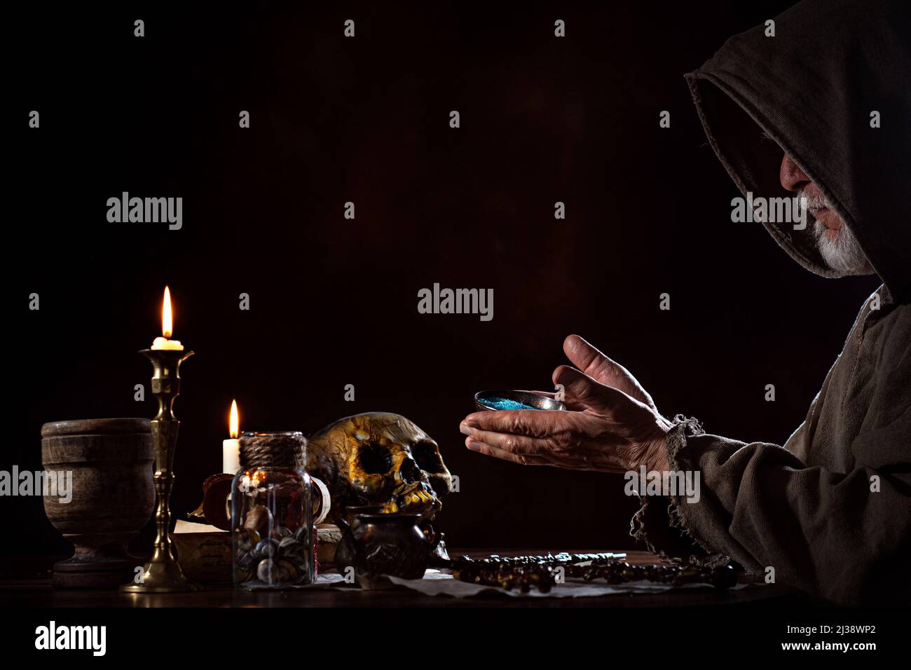 Magician in the Middle Ages with bowl of magic powder Stock Photo - Alamy