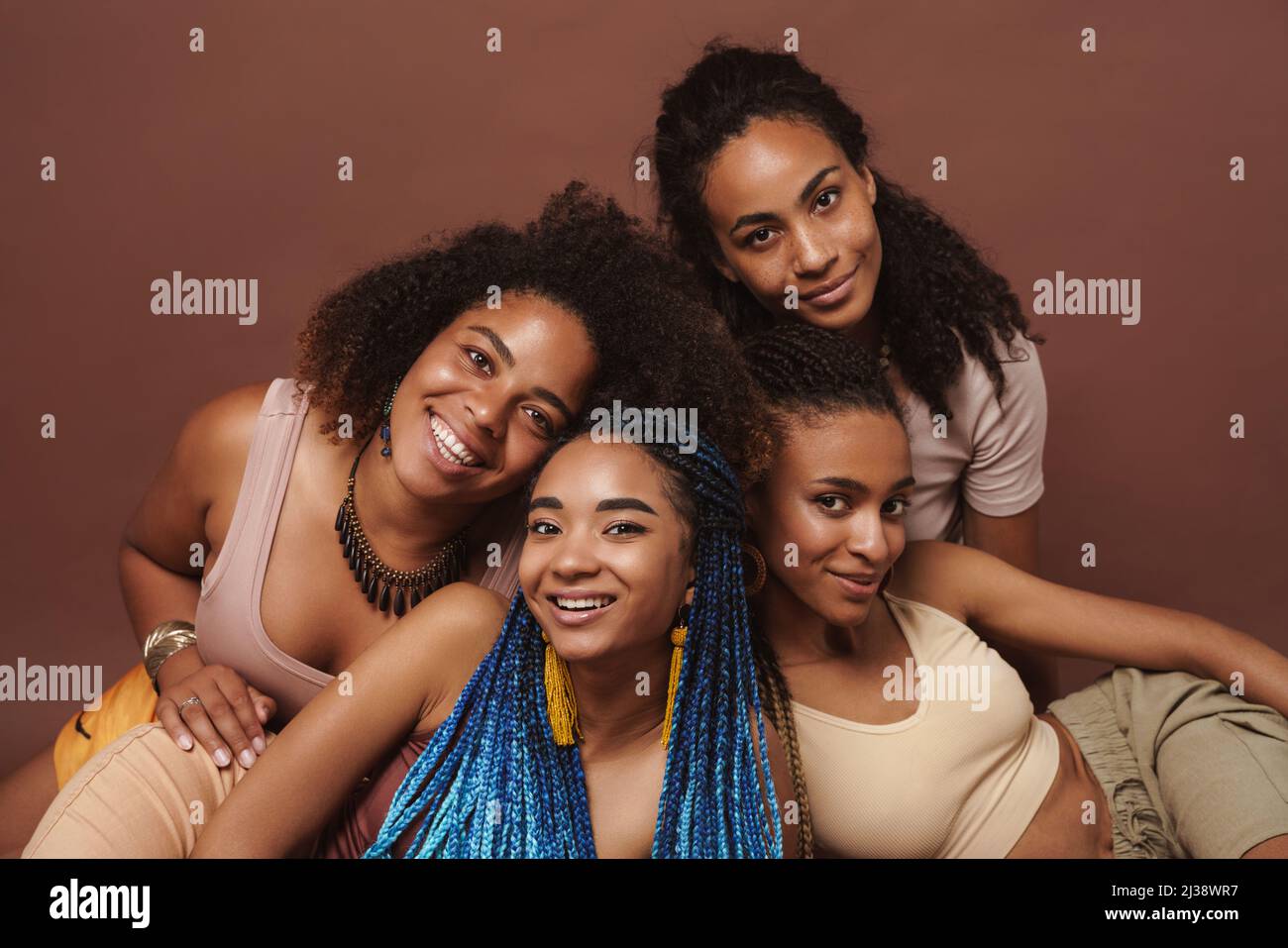 Young black four women smiling while posing together on camera isolated ...