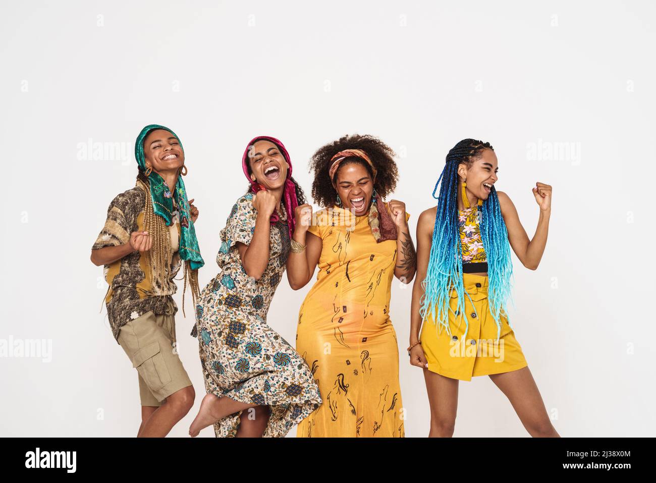 Young black four women screaming while making winner gesture isolated ...