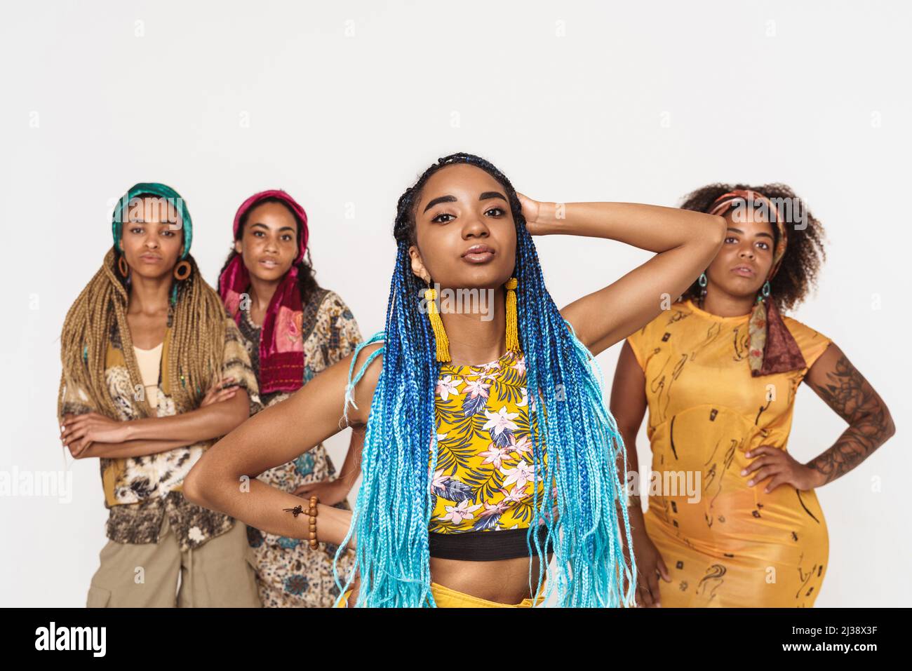 Young black four women wearing dress posing together on camera isolated ...