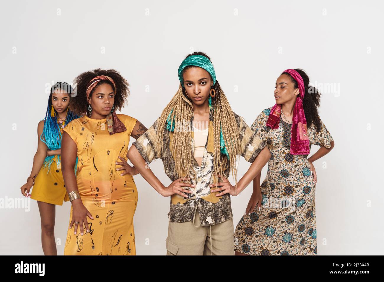 Young black four women wearing dress posing together on camera isolated ...