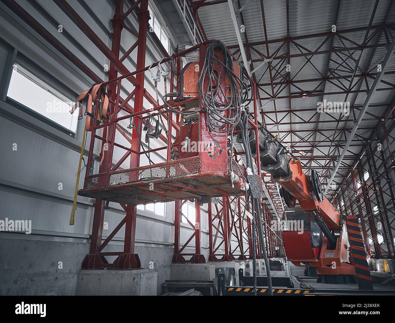Basket of telehandler inside of hangar Stock Photo - Alamy