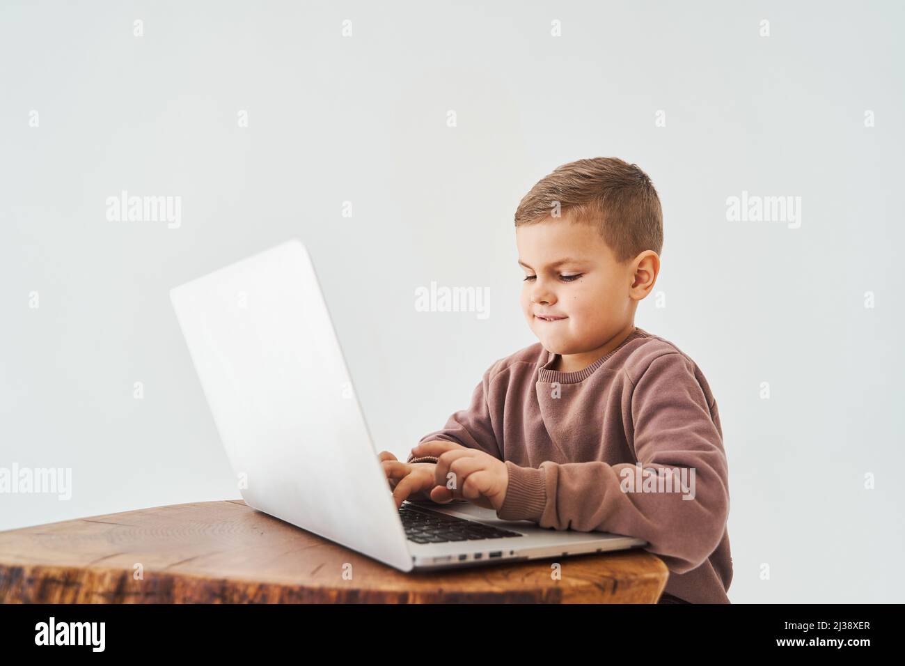 Handsome kid use laptop and look at camera, watch virtual lecture and ...