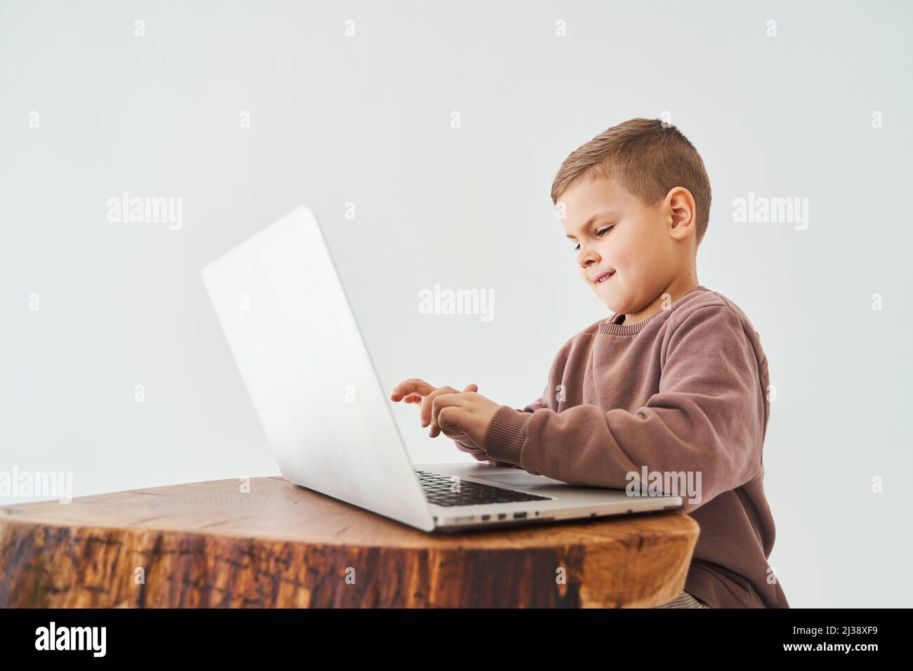 Emotional child with laptop talking with friends online. Handsome kid ...