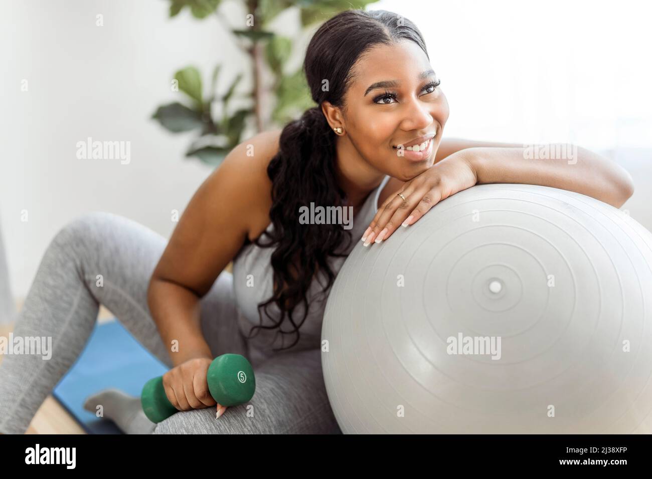 African american woman working out in home livingroom gym with training ...