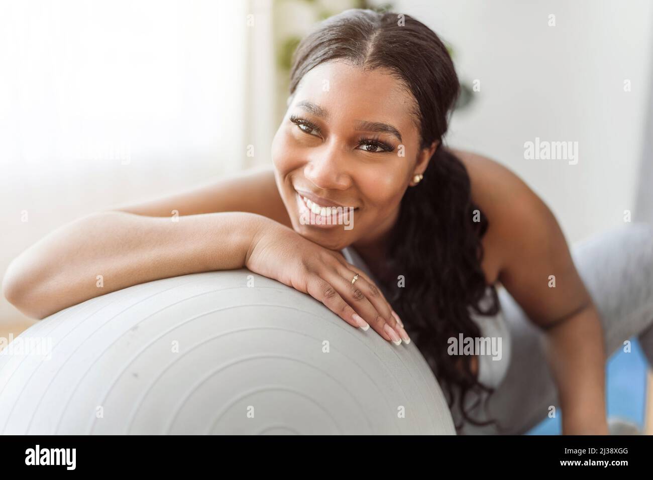 African american woman working out in home livingroom gym with training ...