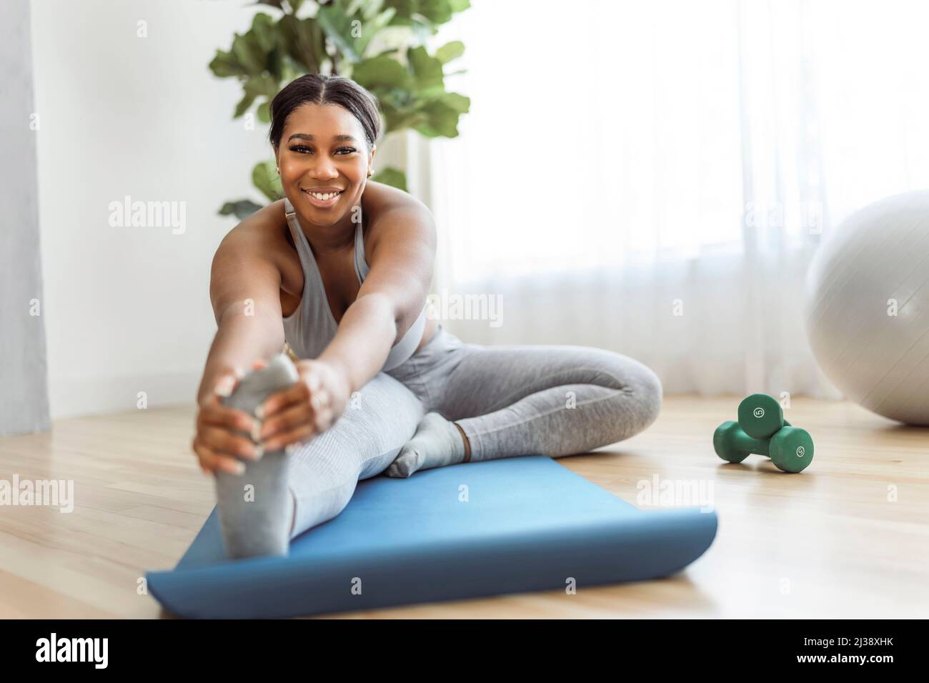 African american woman working out in home livingroom gym Stock Photo ...