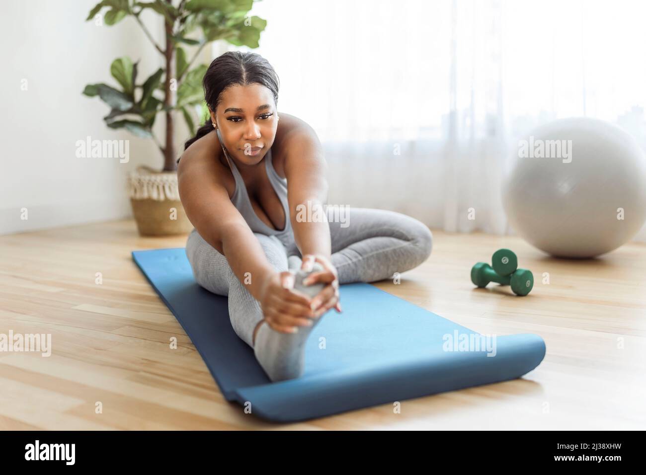 African american woman working out in home livingroom gym Stock Photo ...