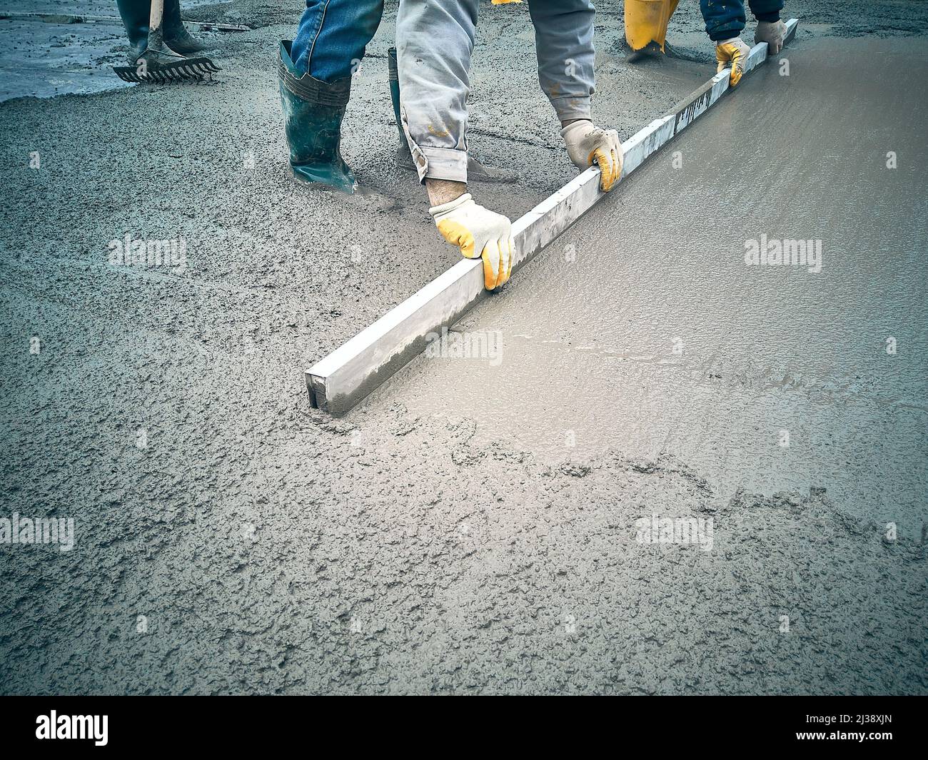 Construction worker levels wet concrete hi-res stock photography and ...