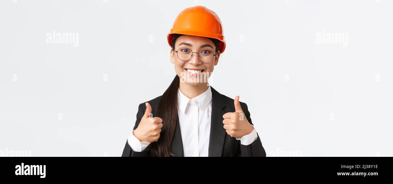 Close-up of professional pleased asian female chief engineer, architect ...