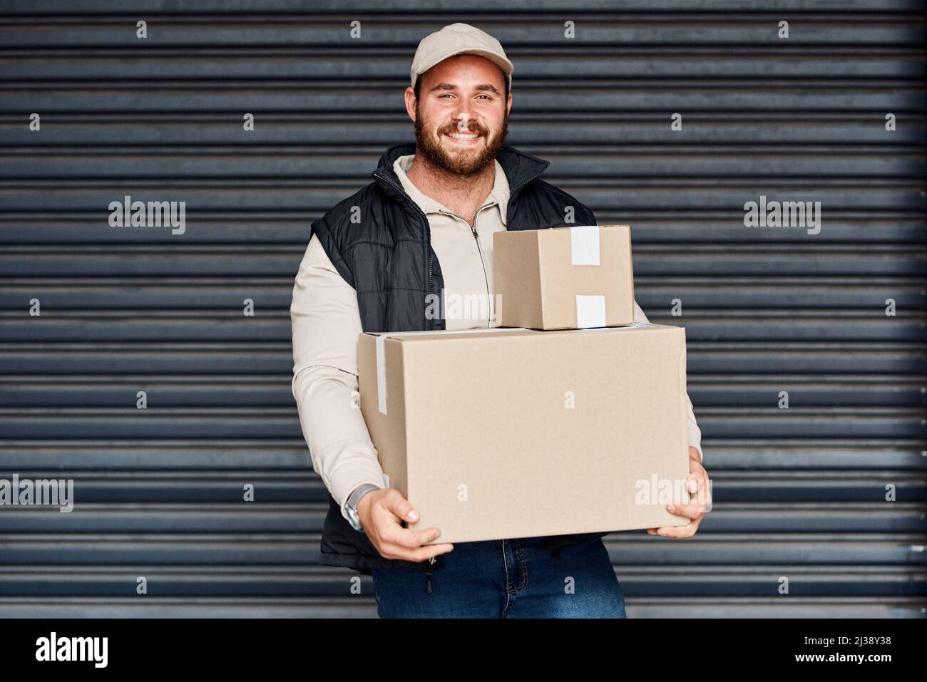 I have your order right here. Portrait of a courier carrying boxes for ...