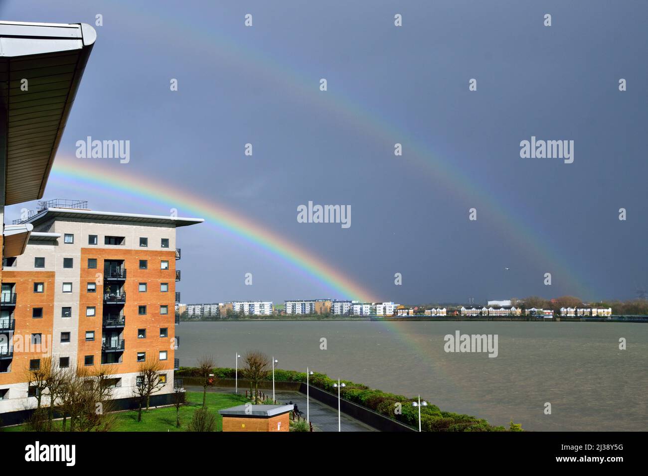 Double rainbow and storm clouds over the River Thames in East London ...