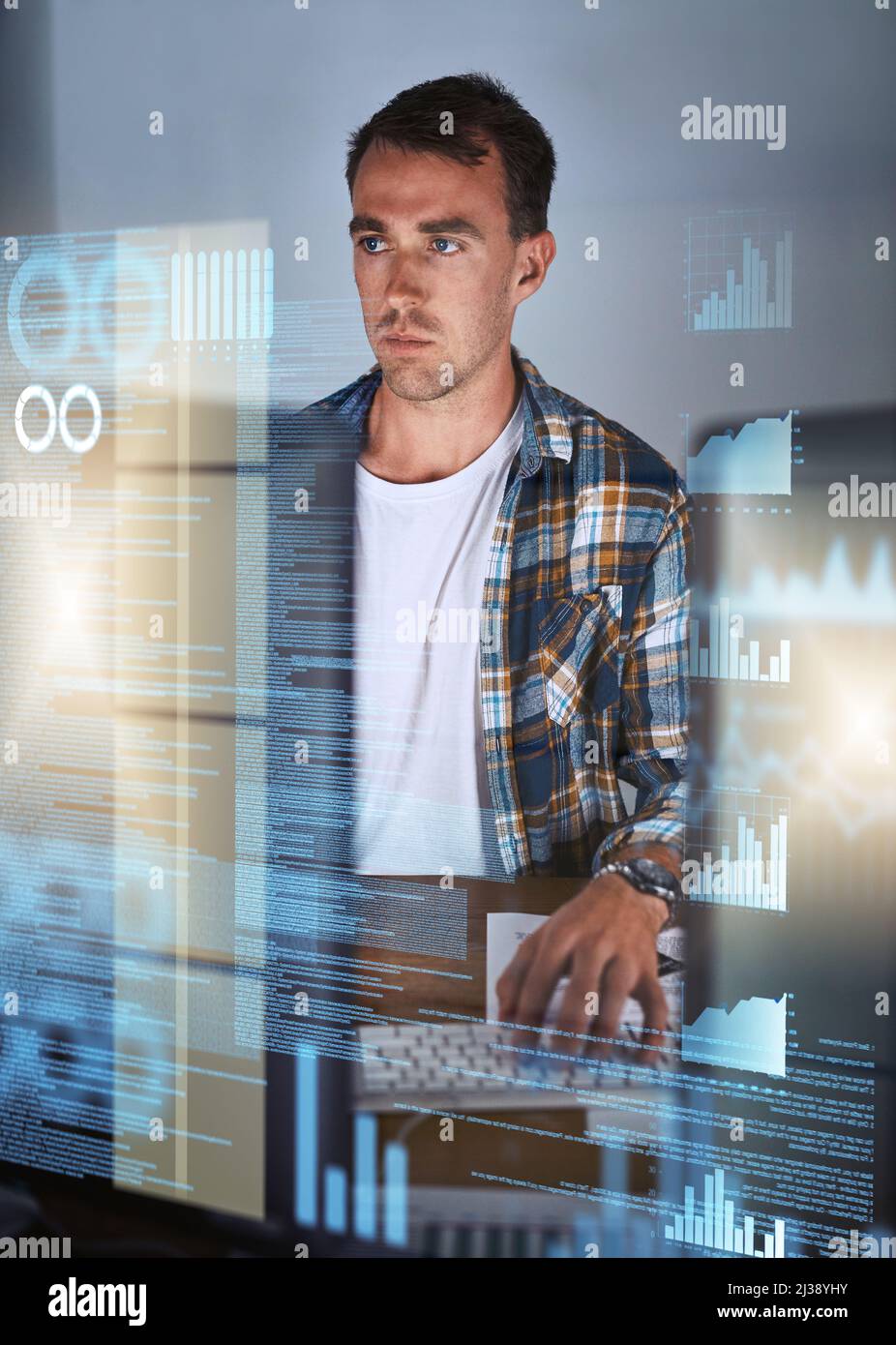 Code is his second language. Shot of a young programmer working at his ...