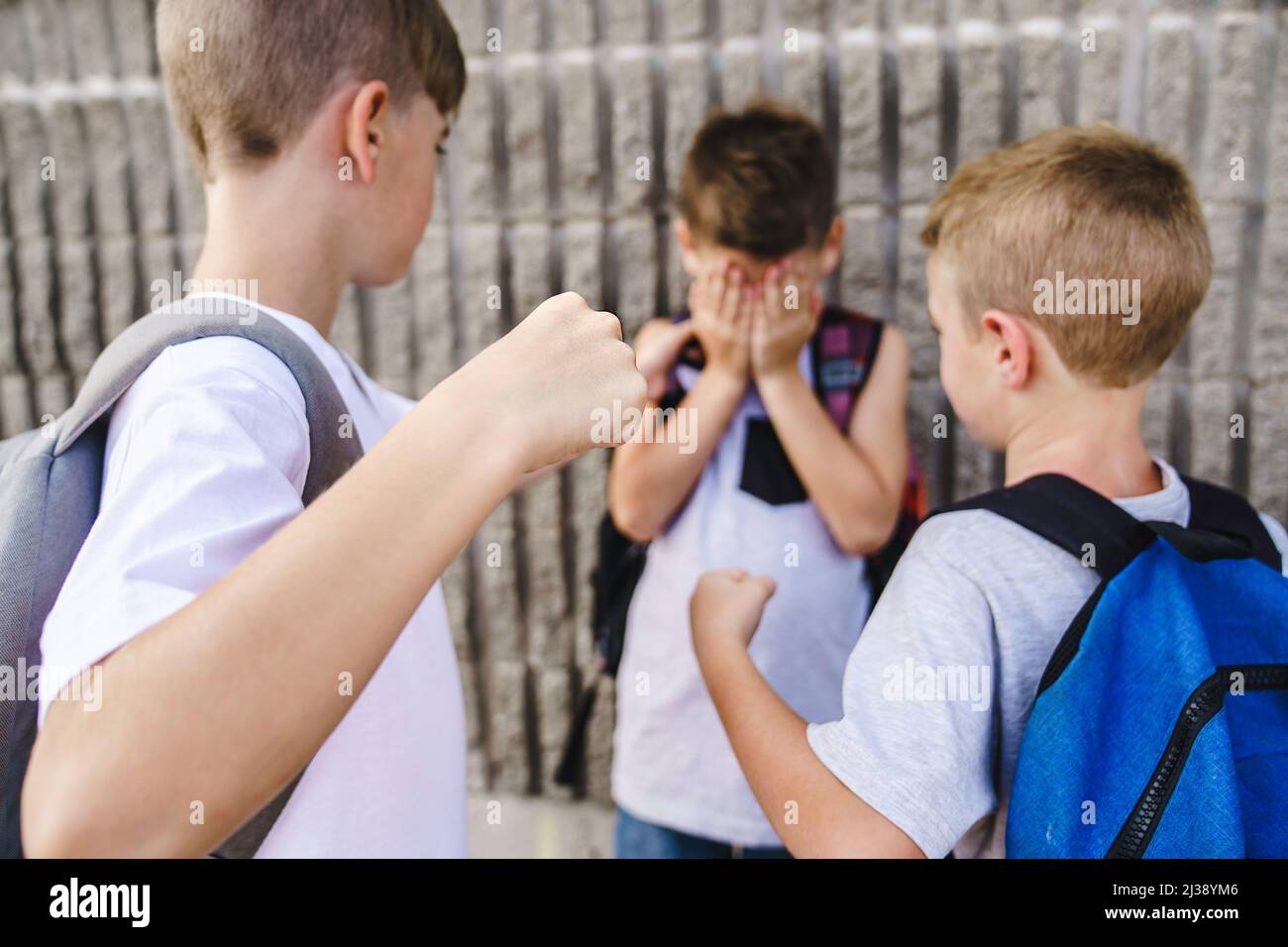 Cruel teenagers punching younger boy, physical intimidation, school ...