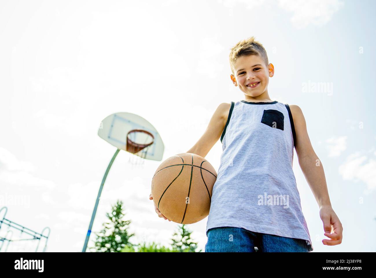 Young Boy Playing Basketball on the summer time Stock Photo - Alamy