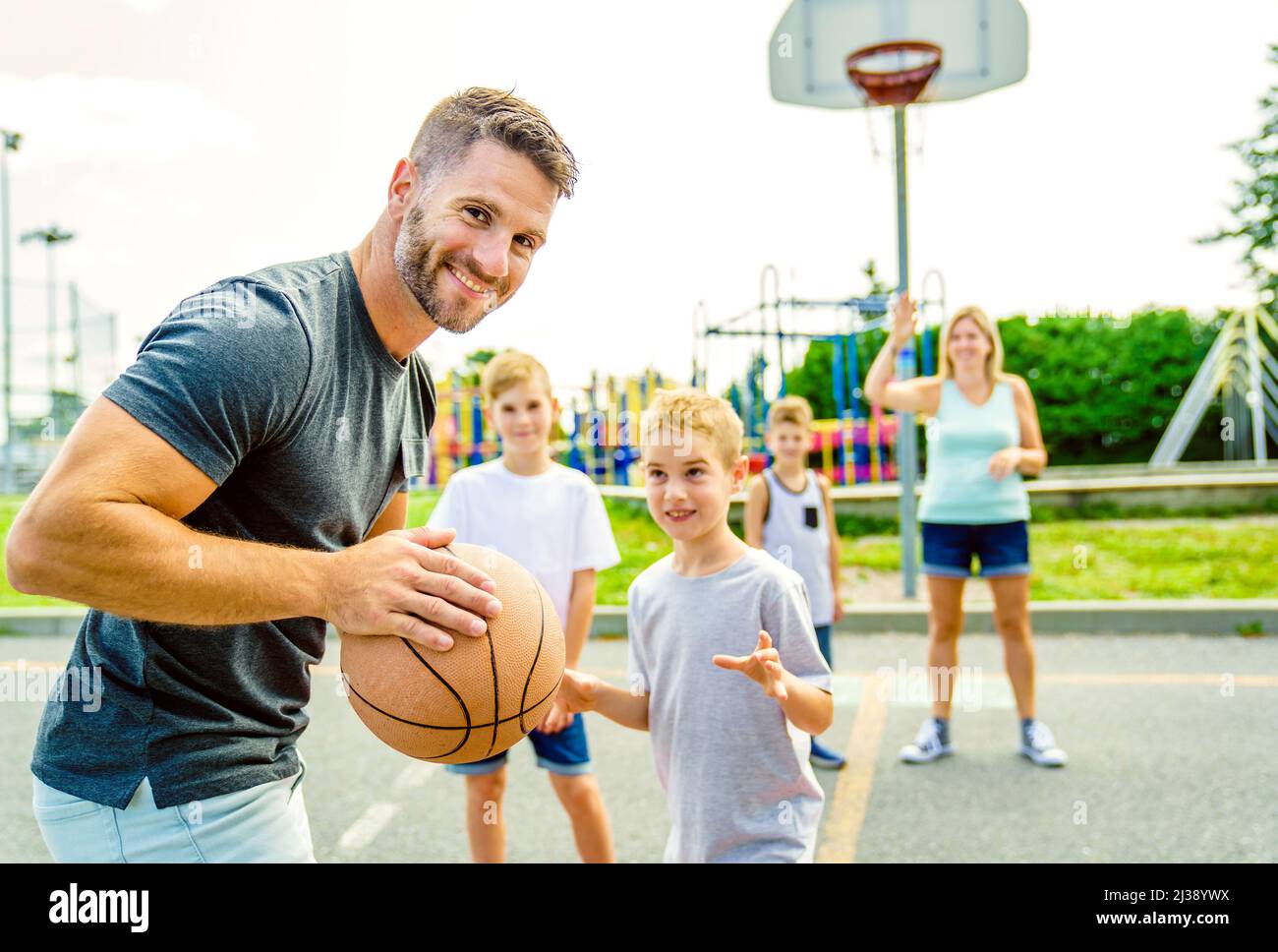 Happy basketball family portrait play this sport on summer season Stock ...