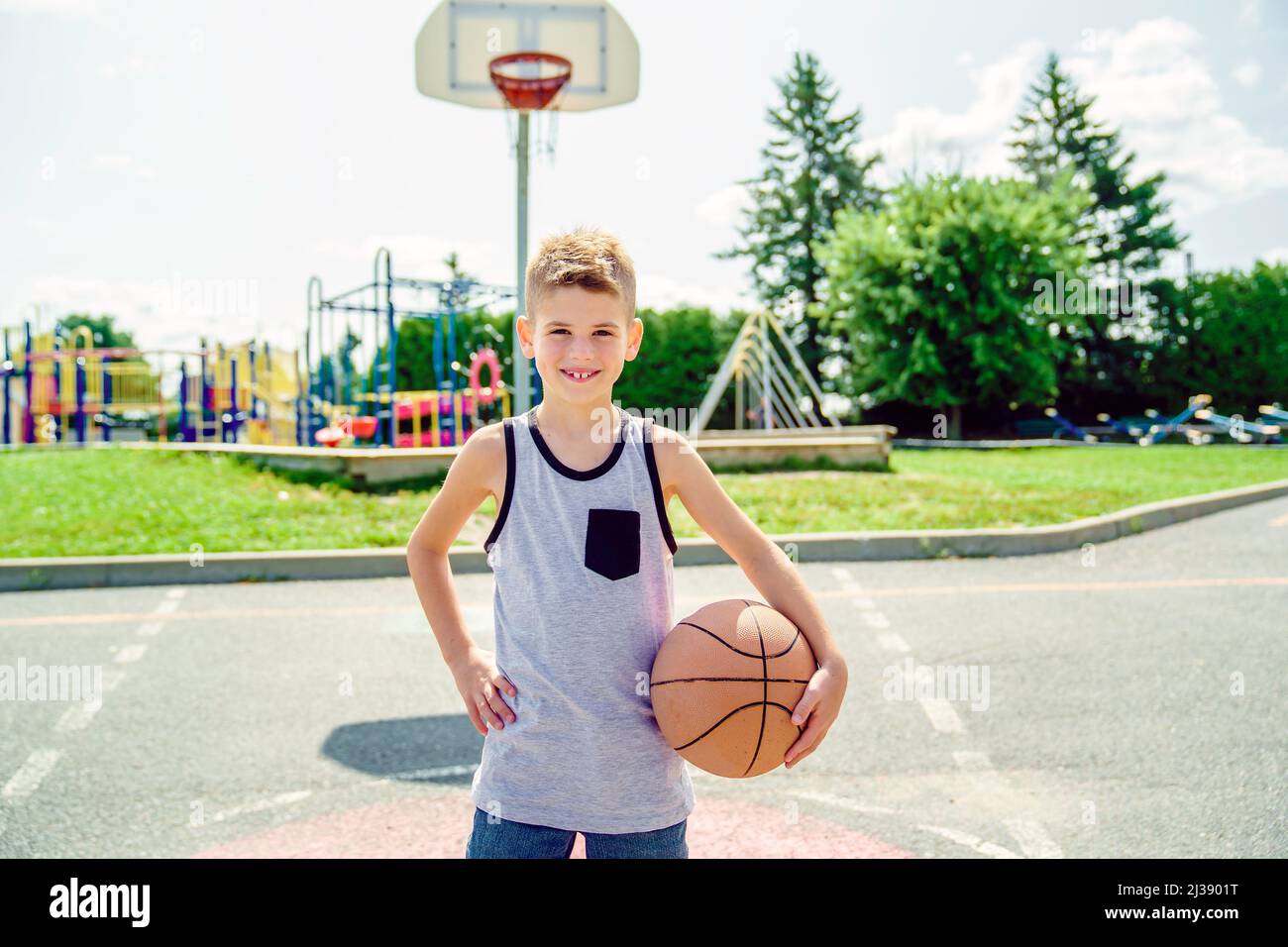 Young Boy Playing Basketball on the summer time Stock Photo - Alamy