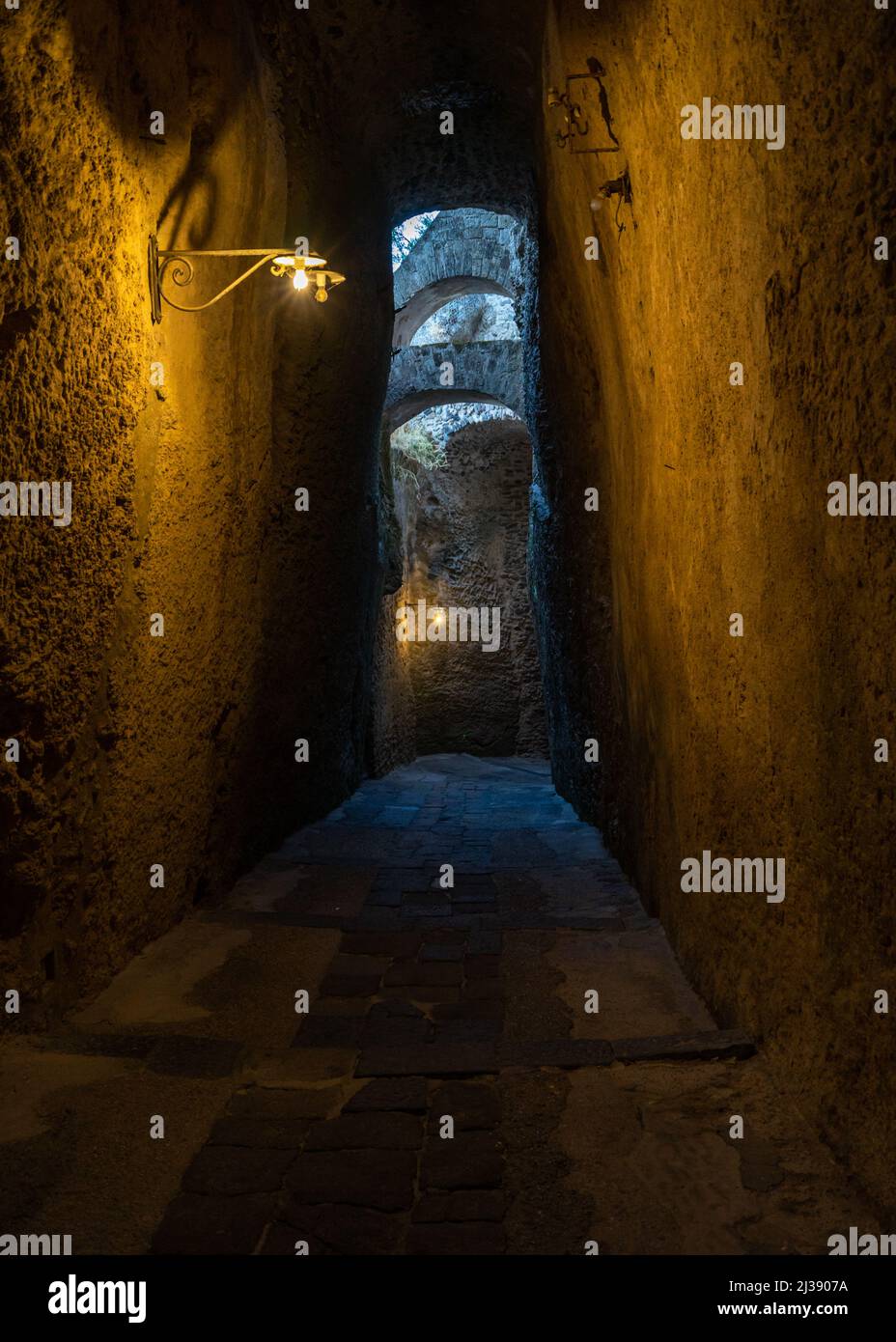 A vertical shot of an alley inside the Aragonese Castle, Ischia, Italy ...