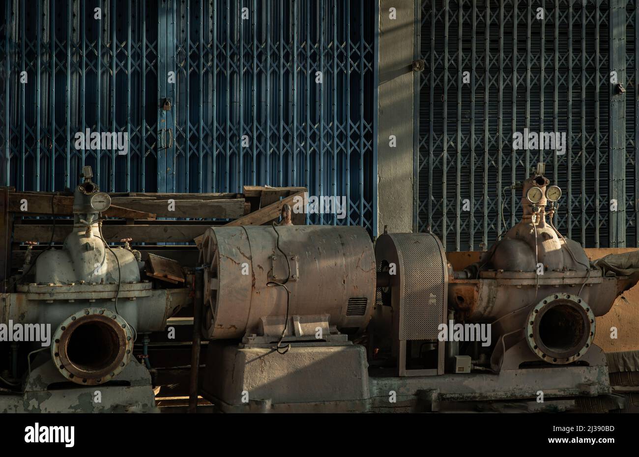 An old and rusty abandoned electric pumps on an abandoned. Engines of ...