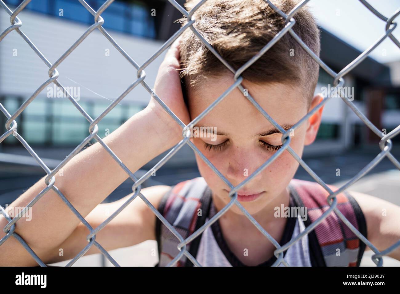 very sad boy bullying in school playground Stock Photo - Alamy