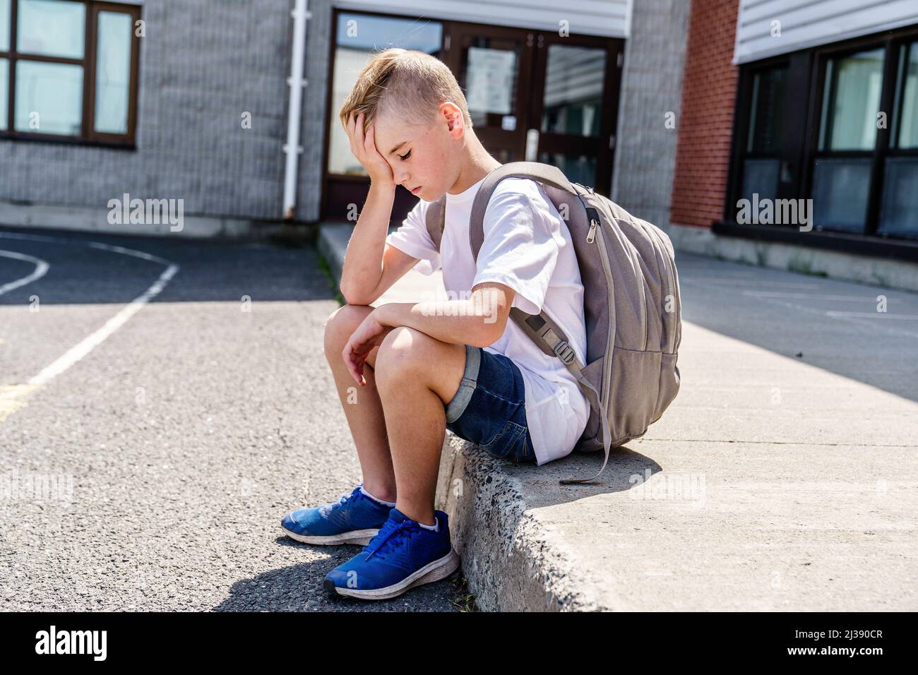 very sad boy bullying in school playground Stock Photo - Alamy