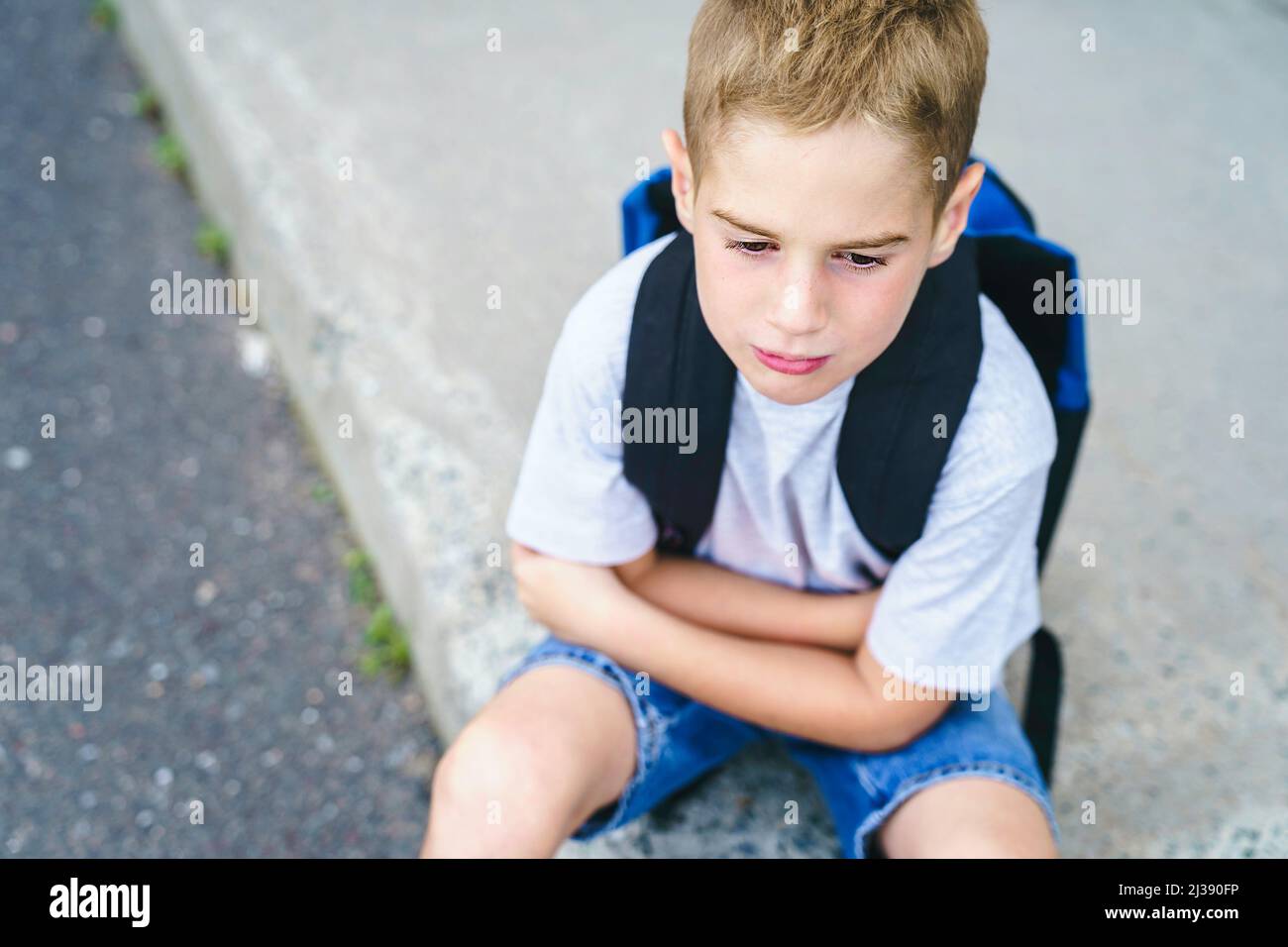 very sad boy bullying in school playground Stock Photo - Alamy