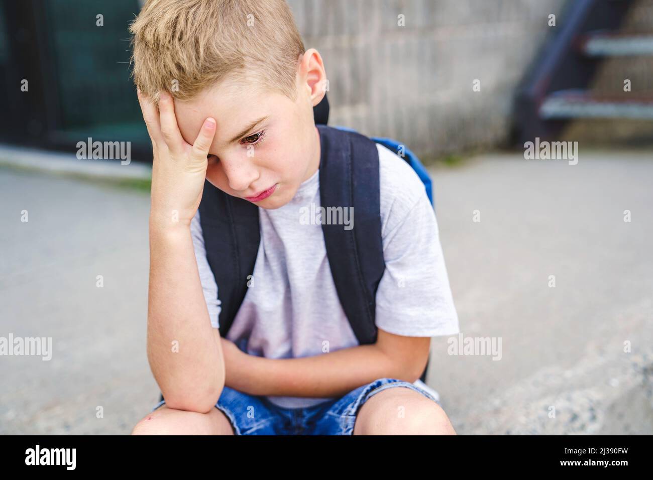 very sad boy bullying in school playground Stock Photo - Alamy