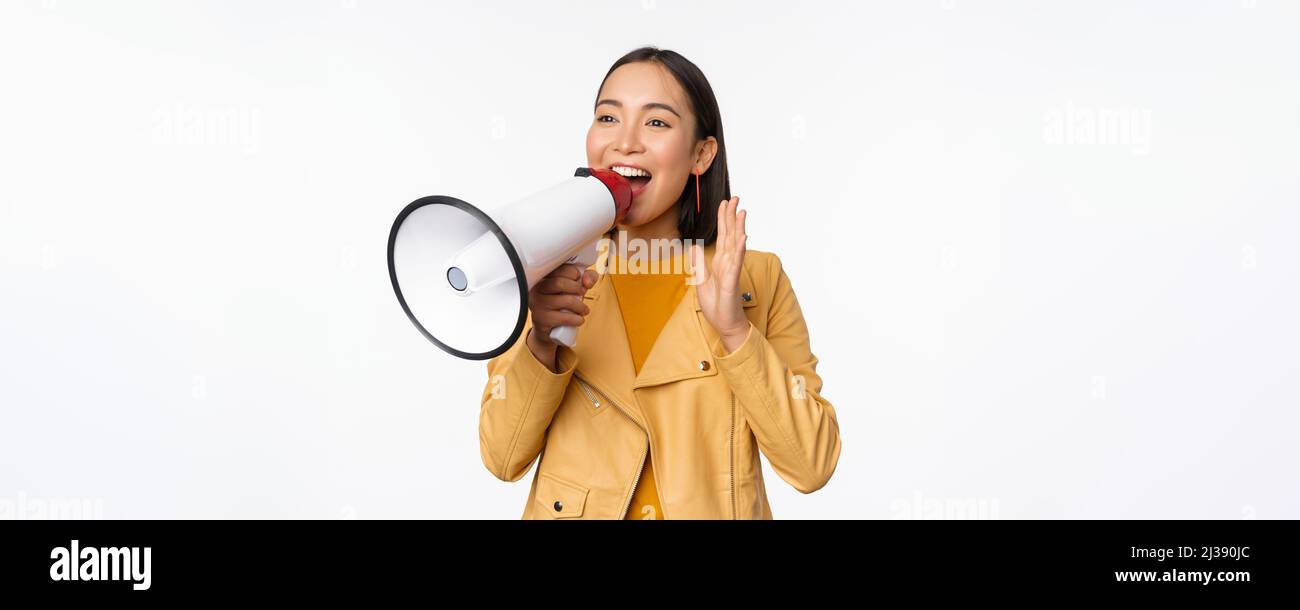 Attention announcement. Image of asian woman shouting in megaphone ...