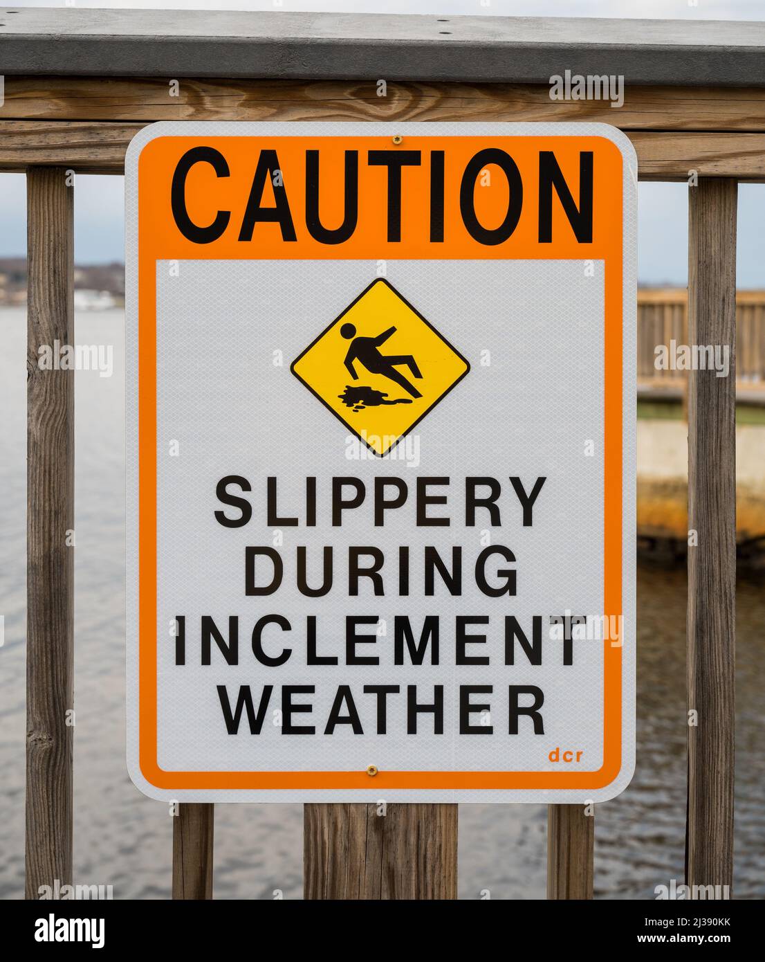 A vertical shot of a caution slippery sign Stock Photo - Alamy