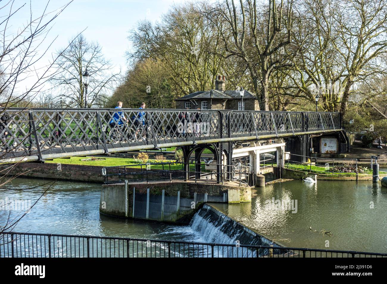 CAMBRIDGE, ENGLAND - MAR 13, 2017: people crossing the river cam at an ...