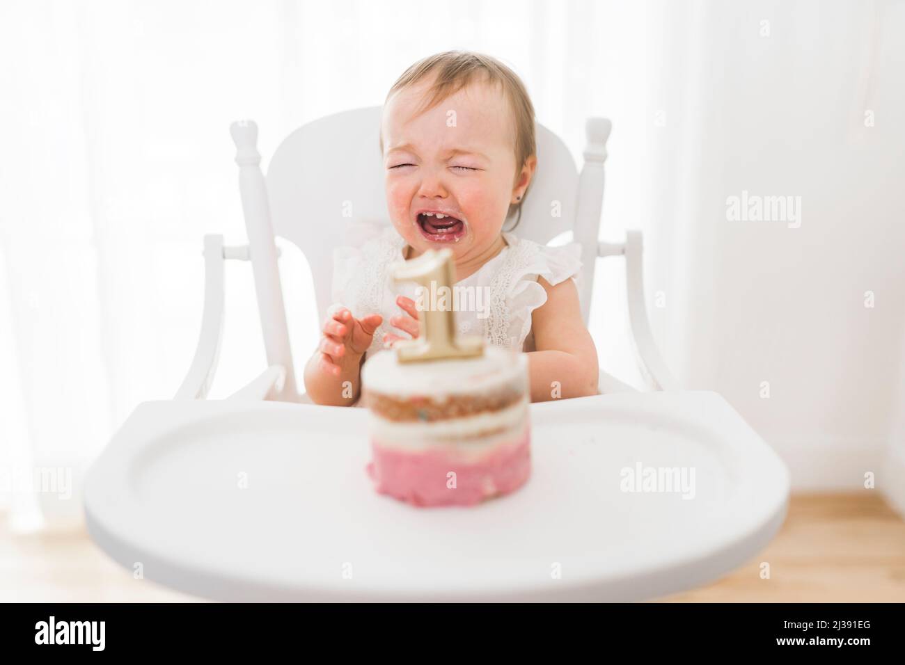 First birthday cake of a baby girl sit on chair crying Stock Photo - Alamy