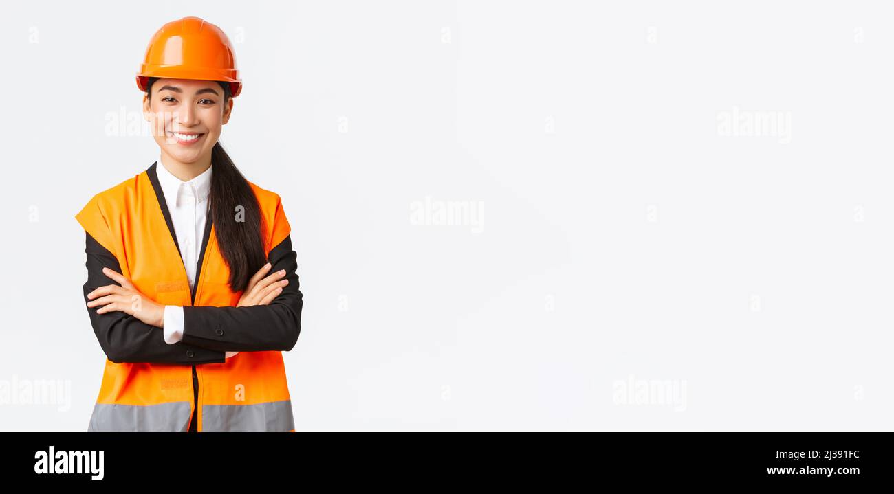 Smiling confident asian female chief manager at building, construction ...