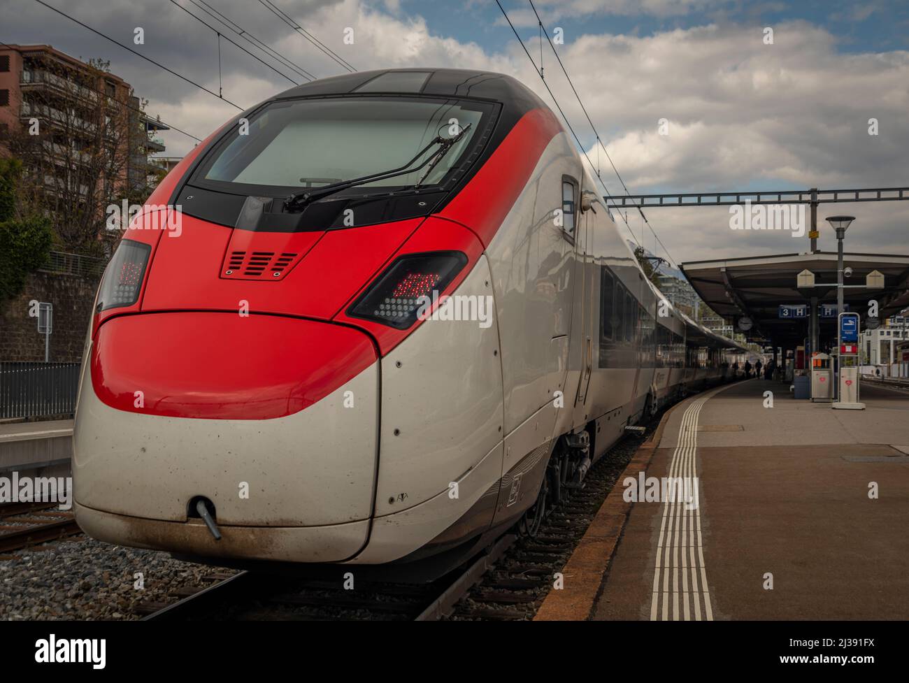 Red fast high speed train in Lugano station in south of Switzerland ...