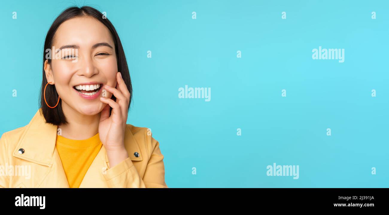 Close up portrait of natural asian girl laughing, smiling and looking ...