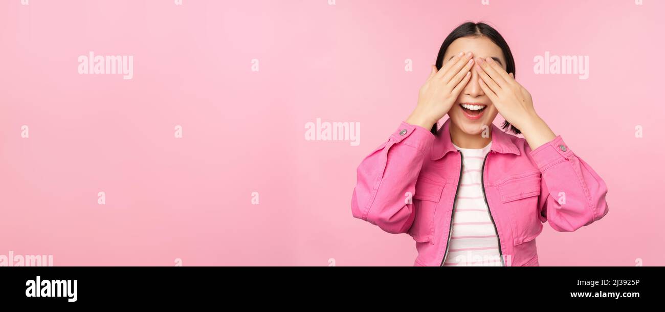 Surprise and celebration. Portrait of asian happy girl close eyes ...