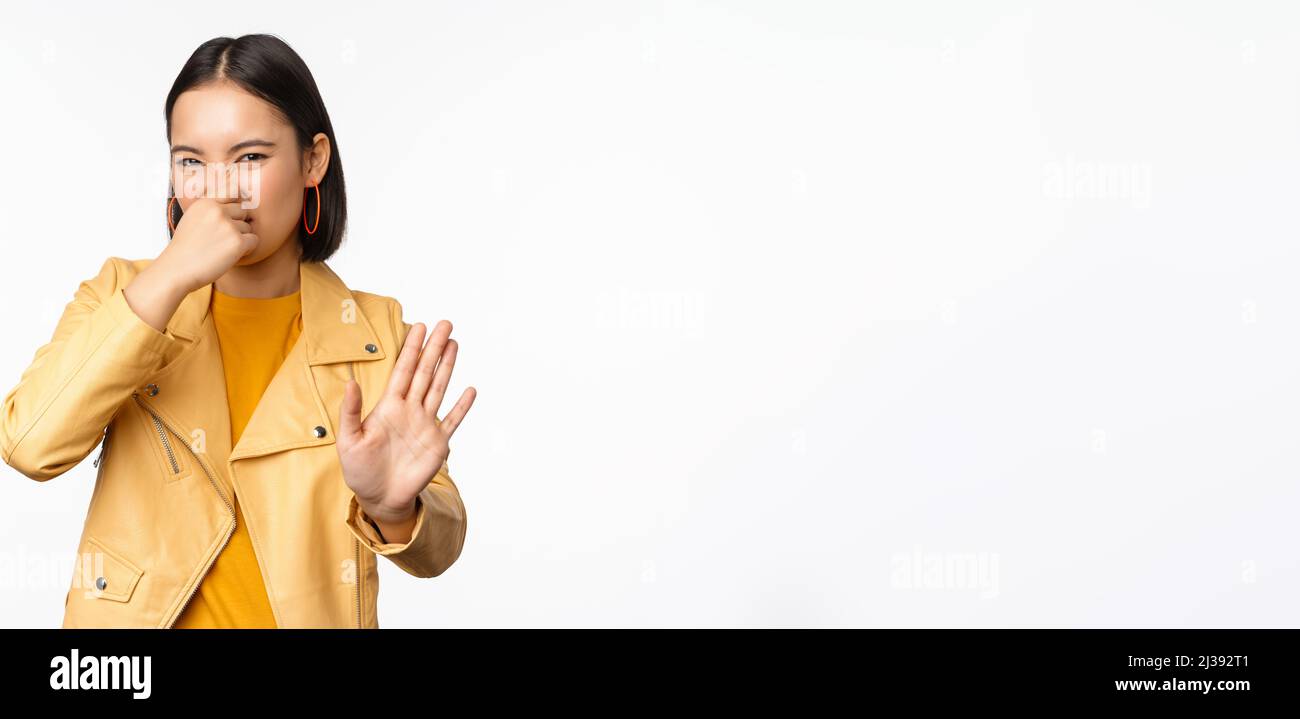 Image of asian girl shuts nose and reject smth with disgusting bad ...